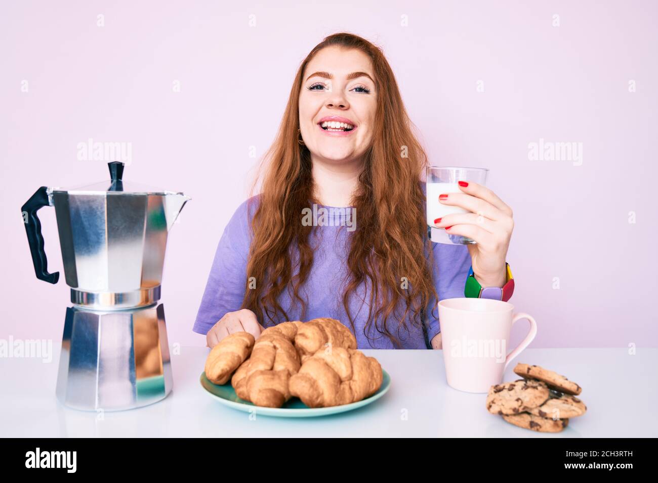 Young redhead woman eating breakfast skeptic and nervous, disapproving ...