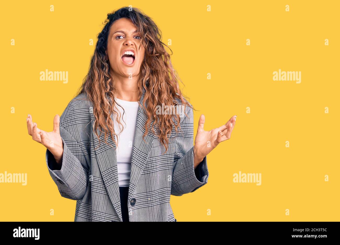 Young hispanic woman with tattoo wearing business oversize jacket crazy ...