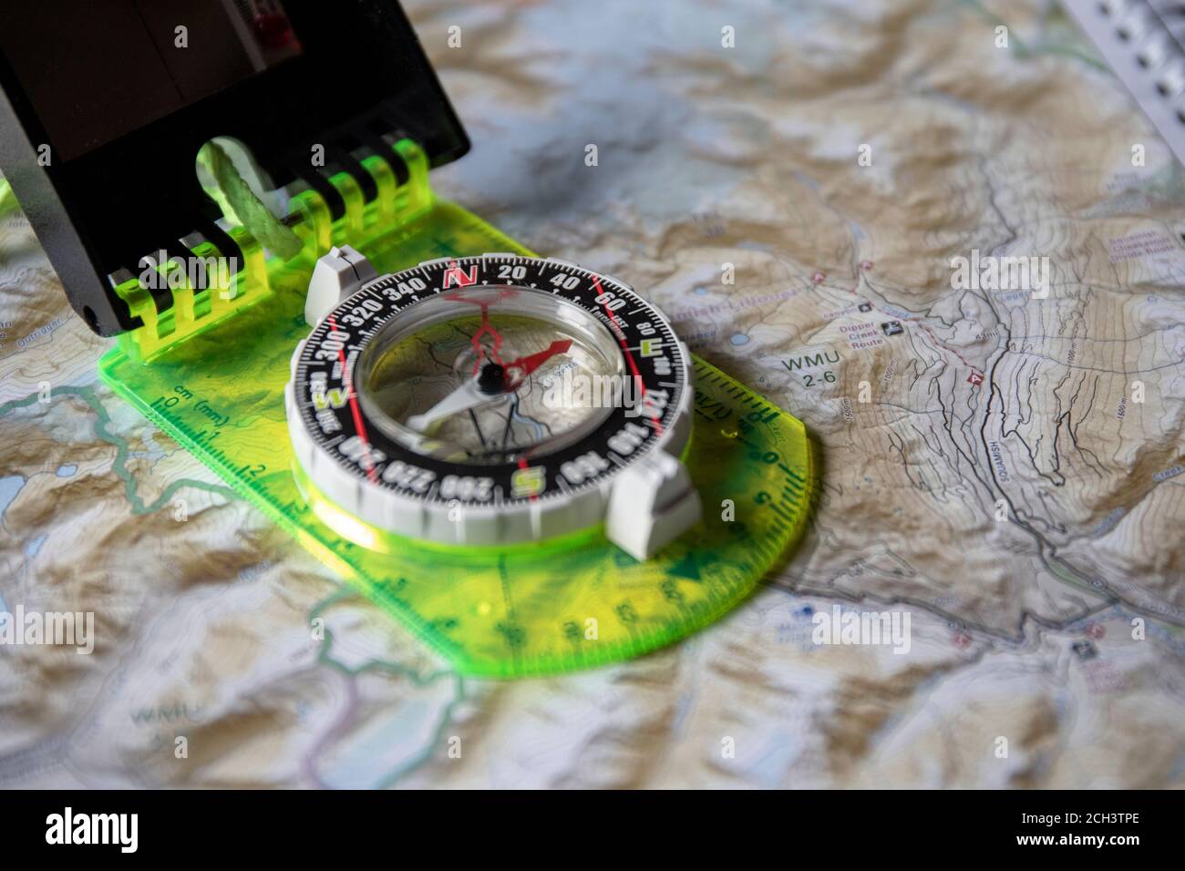 Modern compass placed on map Stock Photo - Alamy