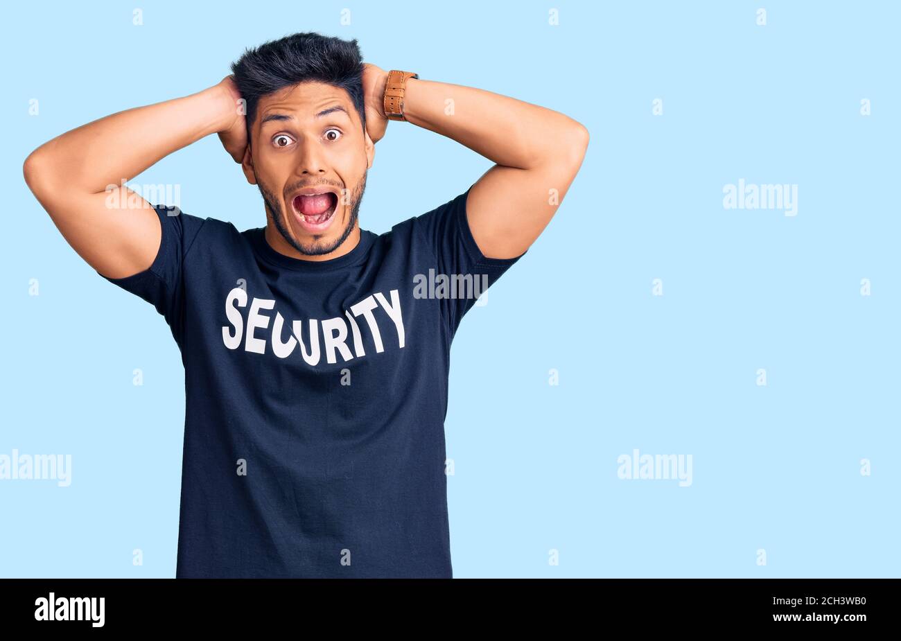 Handsome latin american young man wearing security t shirt crazy and ...