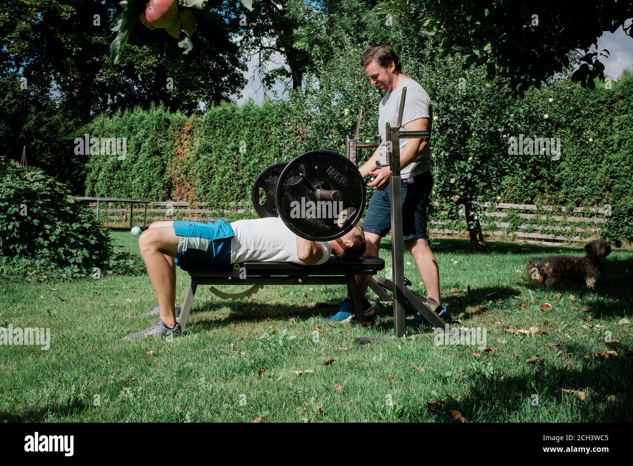 two men working out together at home in the garden gym Stock Photo - Alamy