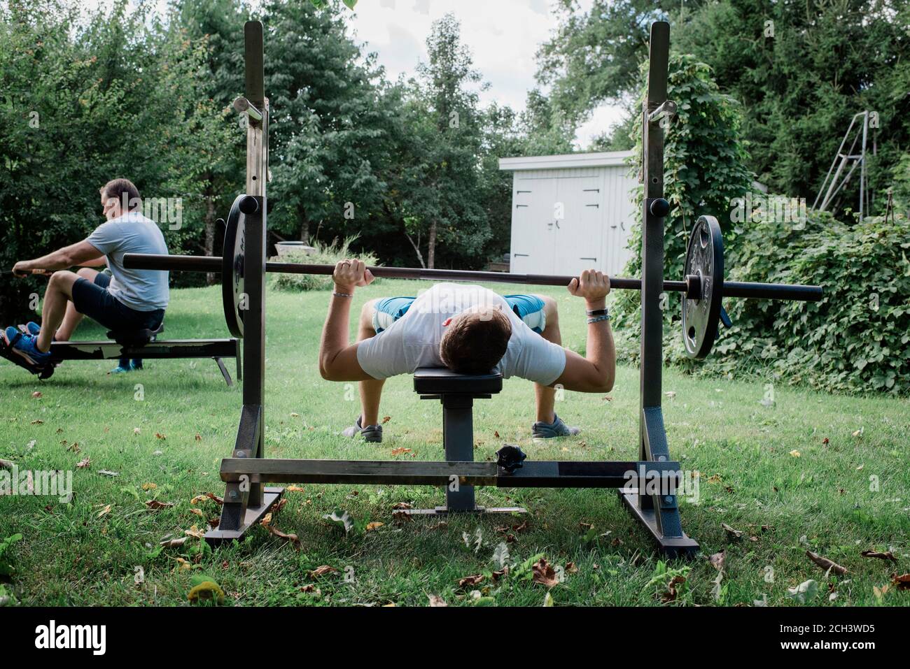 two men working out in the garden in their home gym Stock Photo - Alamy