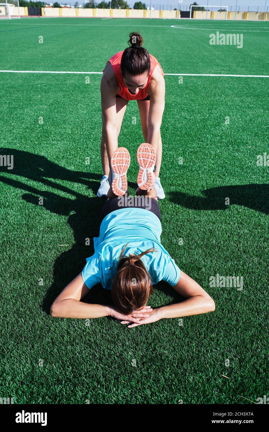 two women help each other practice their stretching Stock Photo - Alamy