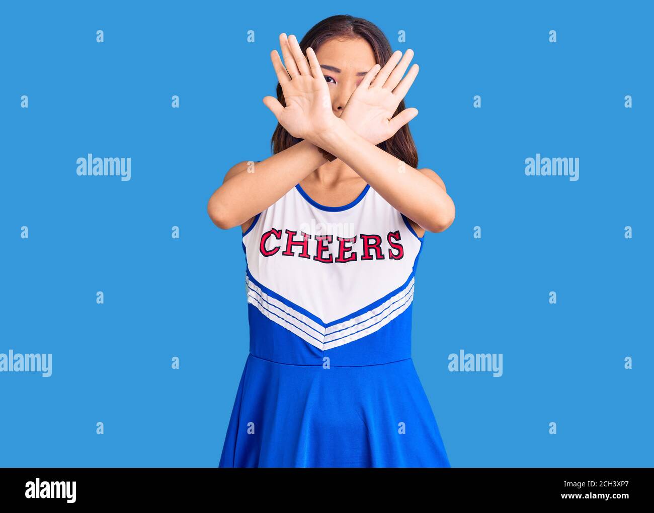 Young beautiful chinese girl wearing cheerleader uniform rejection ...