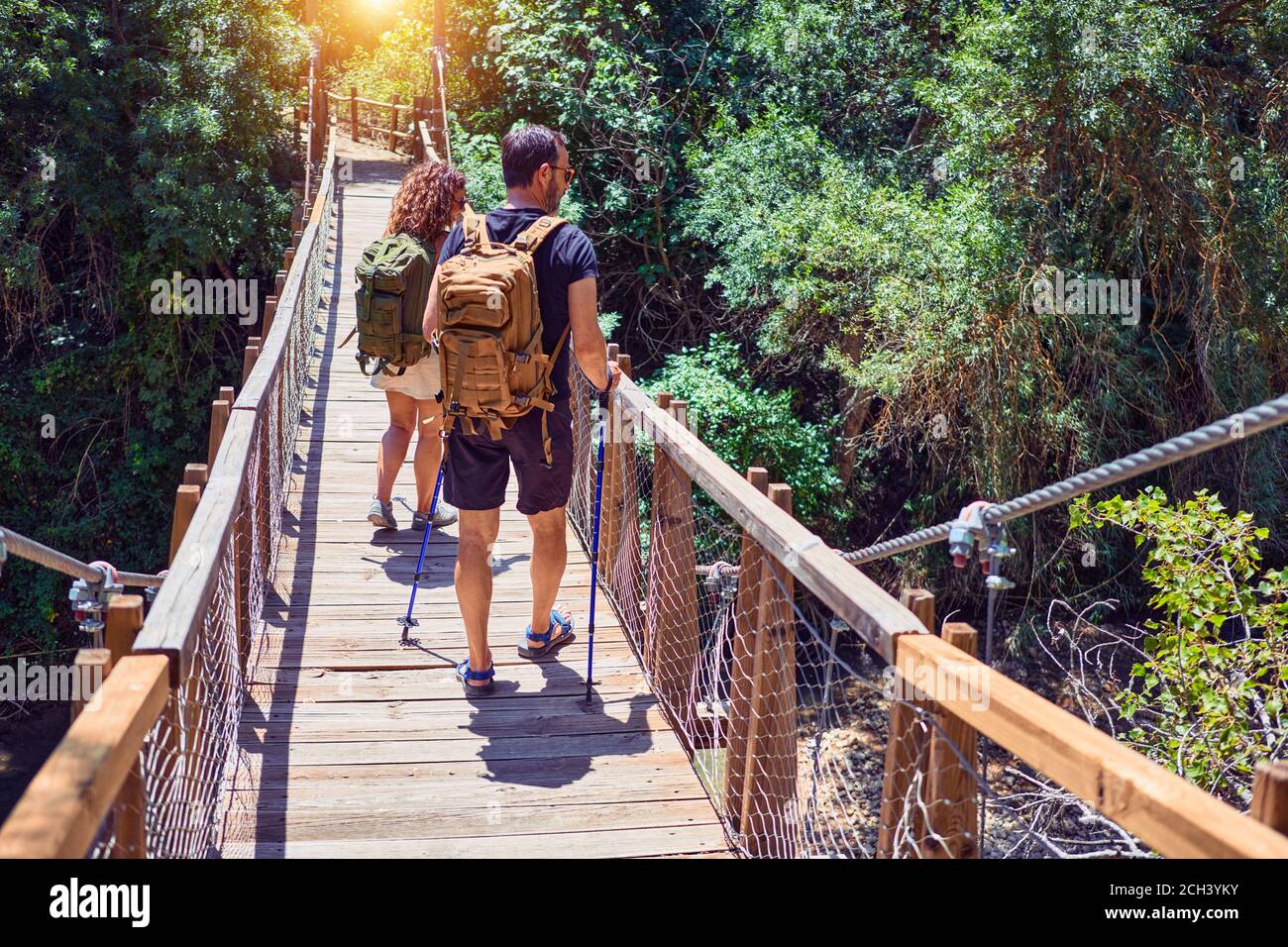 Beautiful couple of hiker wearing explorer clothes and backpack ...