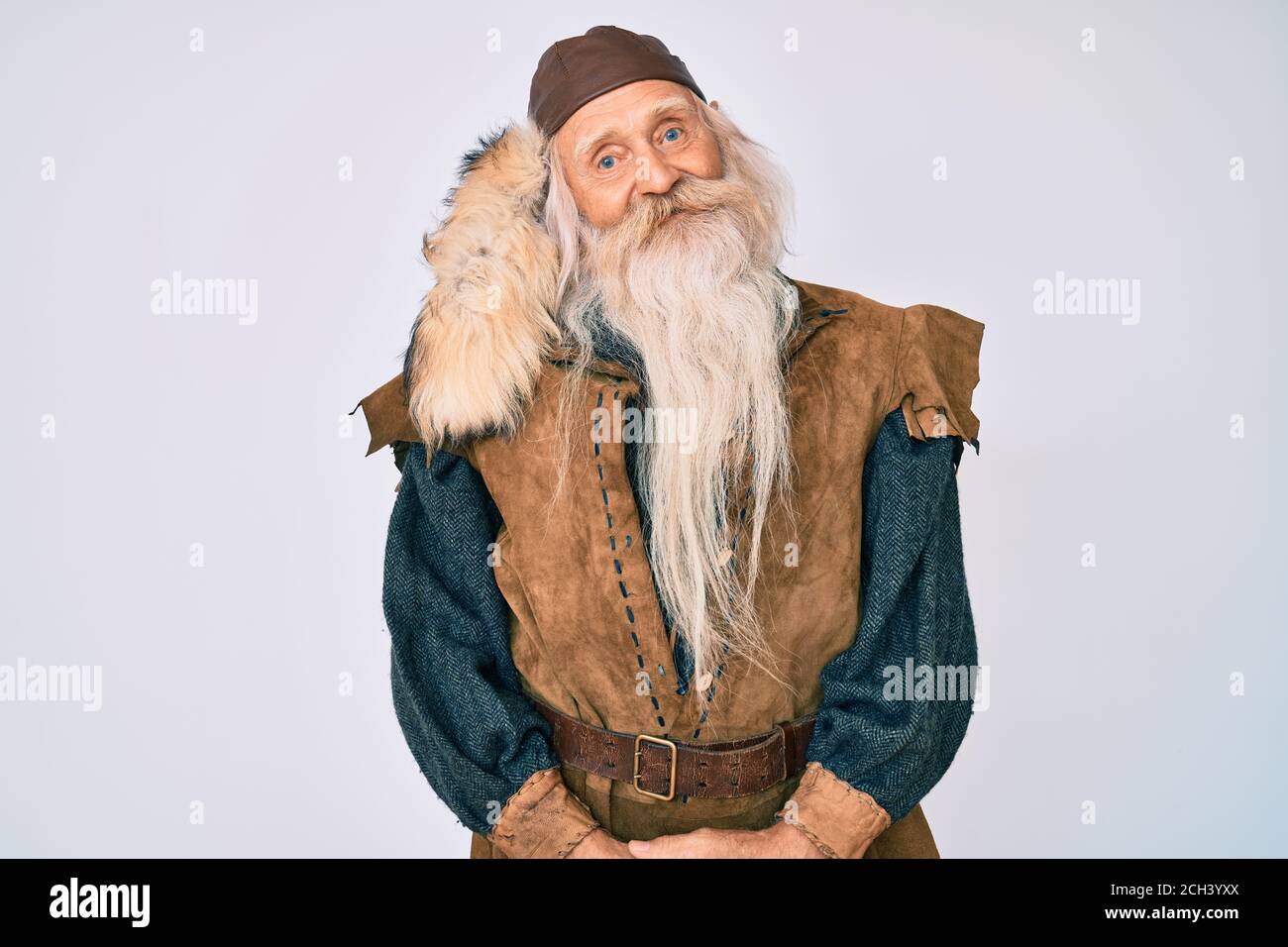 Old senior man with grey hair and long beard wearing viking traditional ...