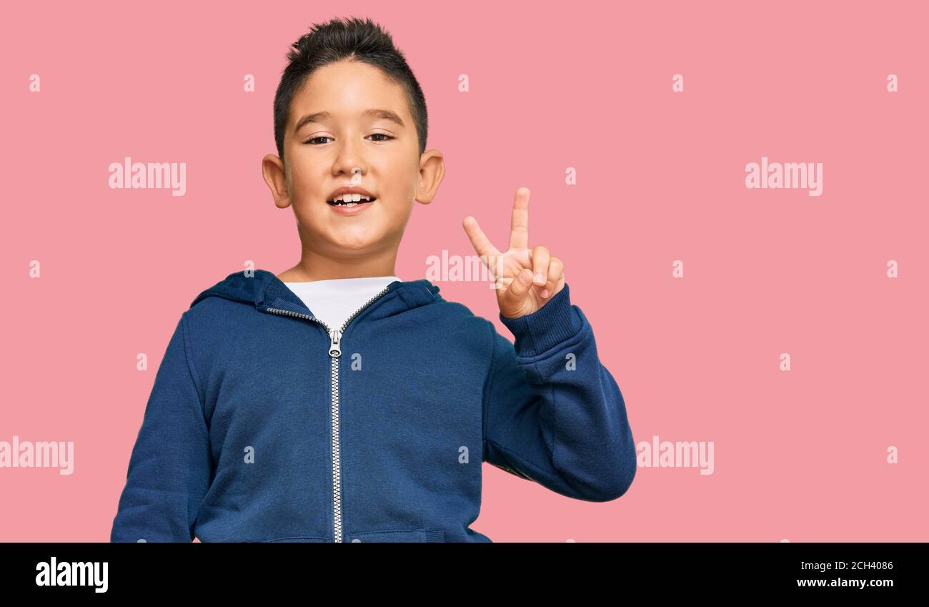 Little boy hispanic kid wearing casual sporty jacket smiling with happy ...