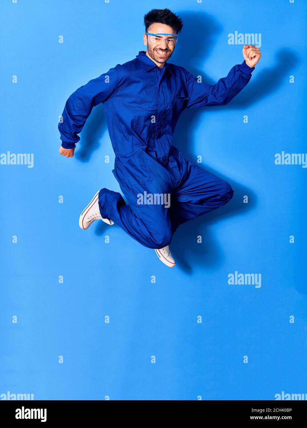 Young handsome hispanic man wearing painter uniform and glasses smiling ...