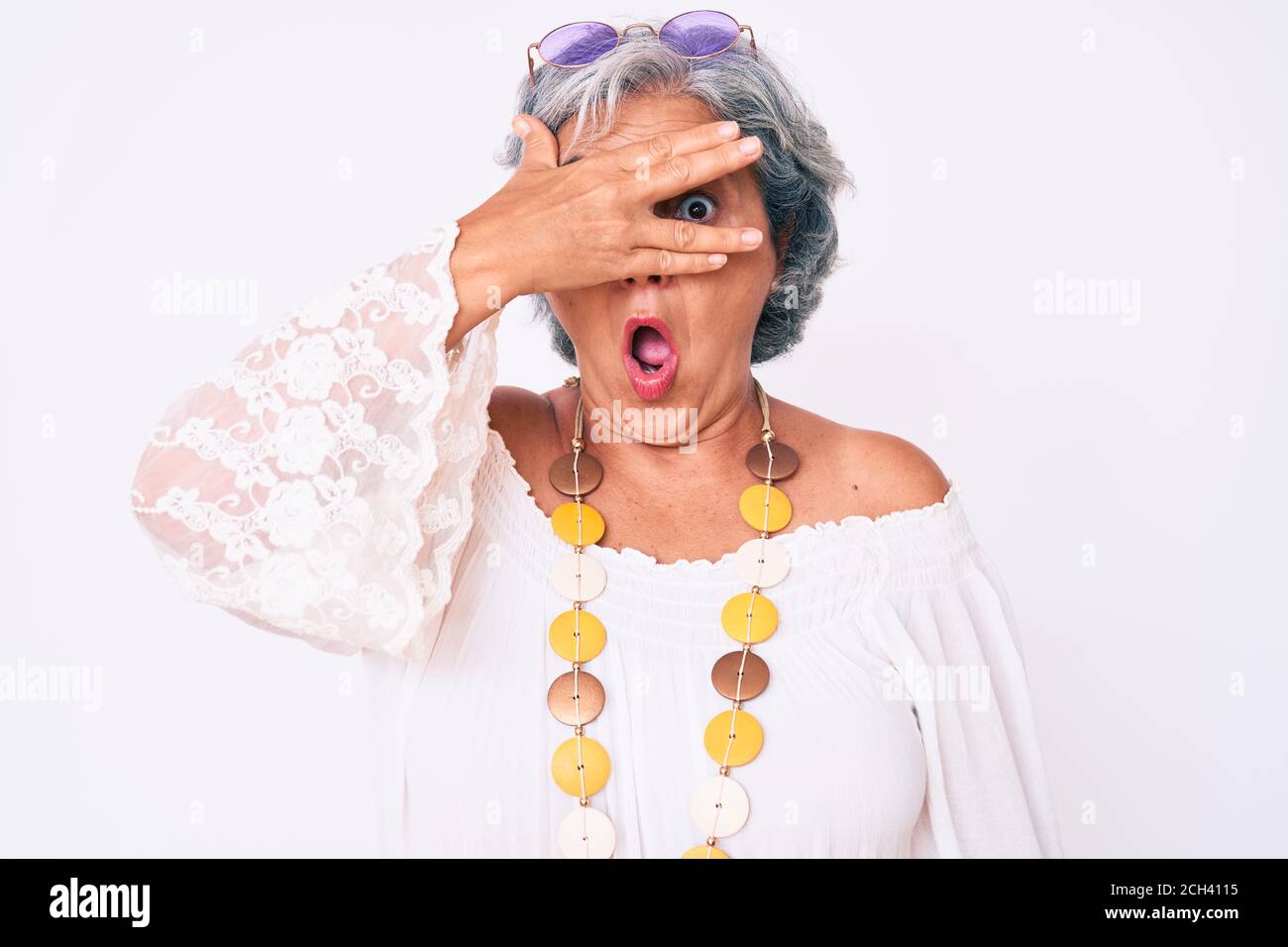 Senior hispanic grey- haired woman wearing casual hippie clothes ...