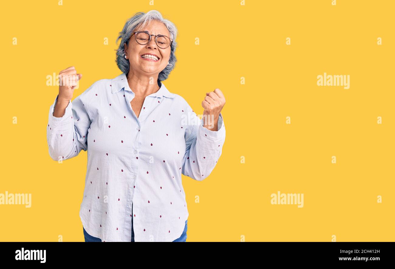 Senior woman with gray hair wearing casual business clothes and glasses ...