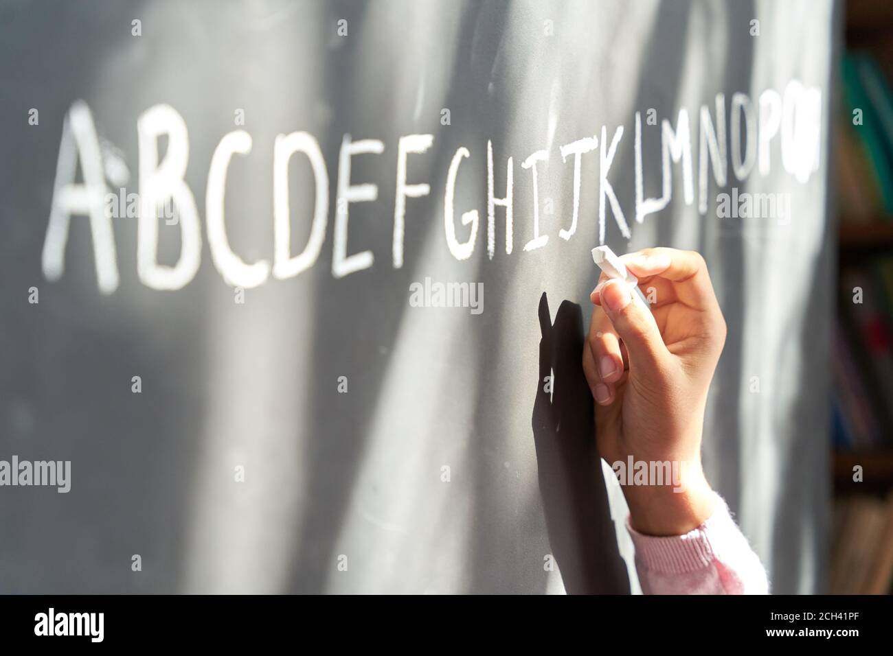 Children holding alphabet letters hi-res stock photography and images ...