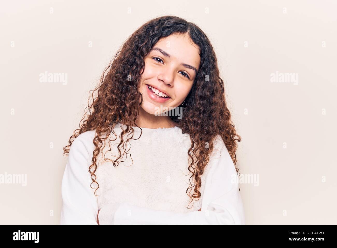 Beautiful kid girl with curly hair wearing casual clothes happy face ...