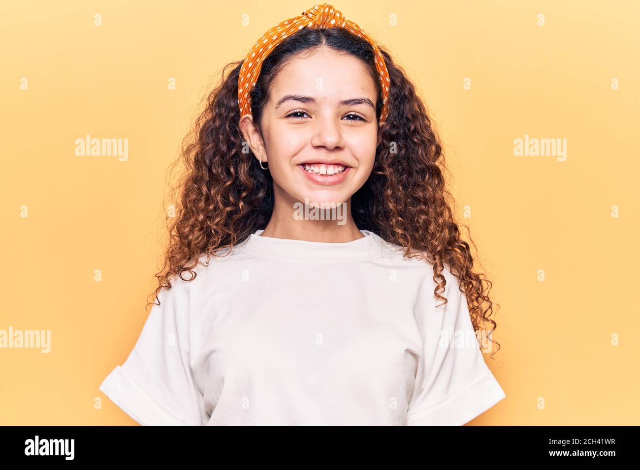 Beautiful kid girl with curly hair wearing casual clothes looking ...