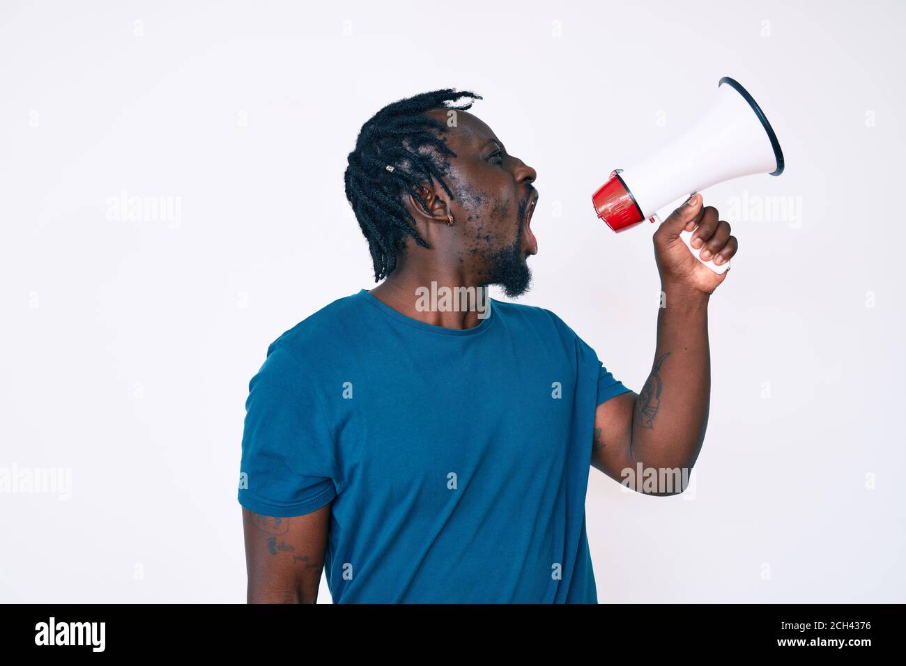 Young handsome african american man screaming using megaphone over ...