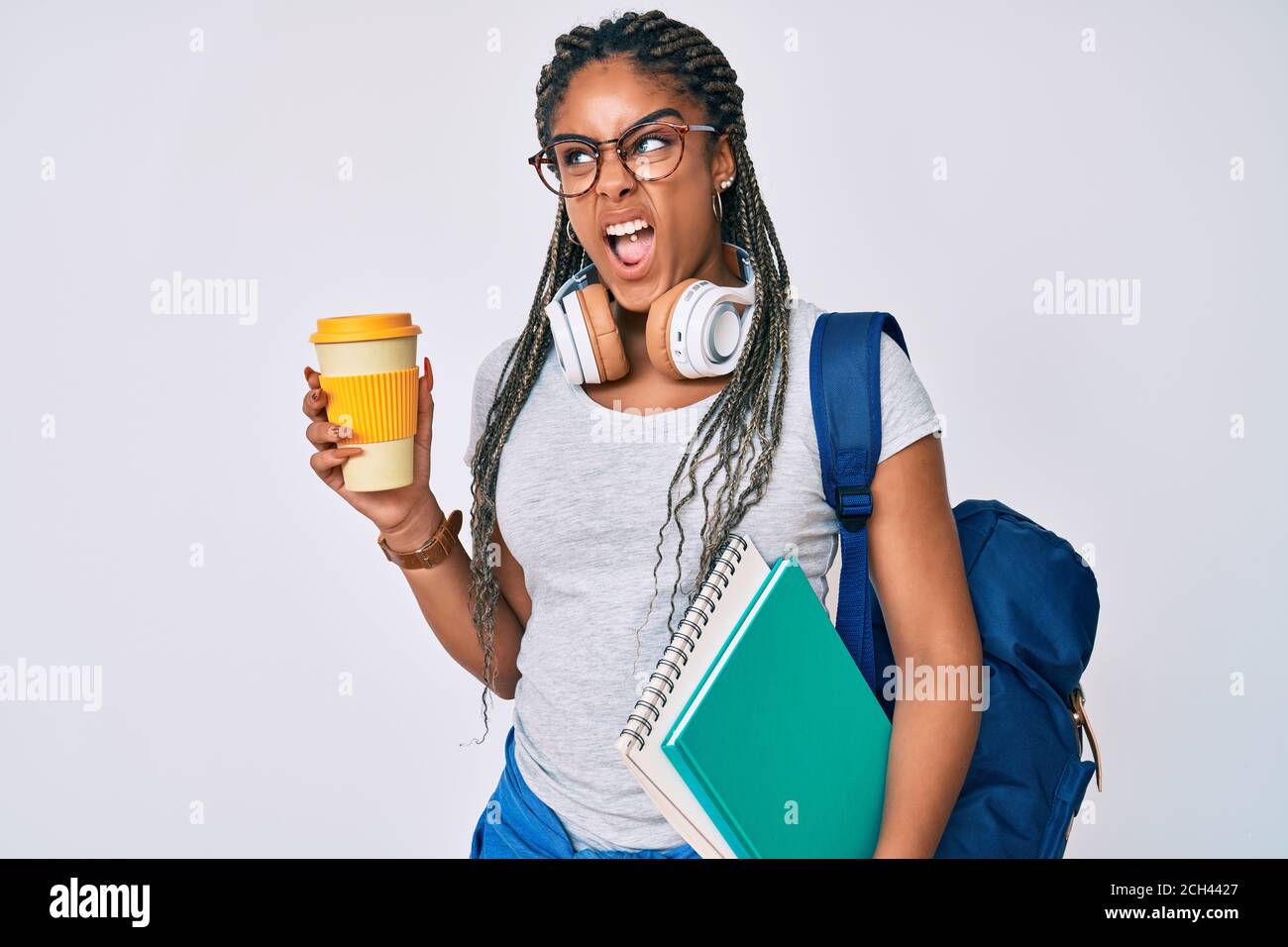 Young african american woman with braids wearing student backpack ...