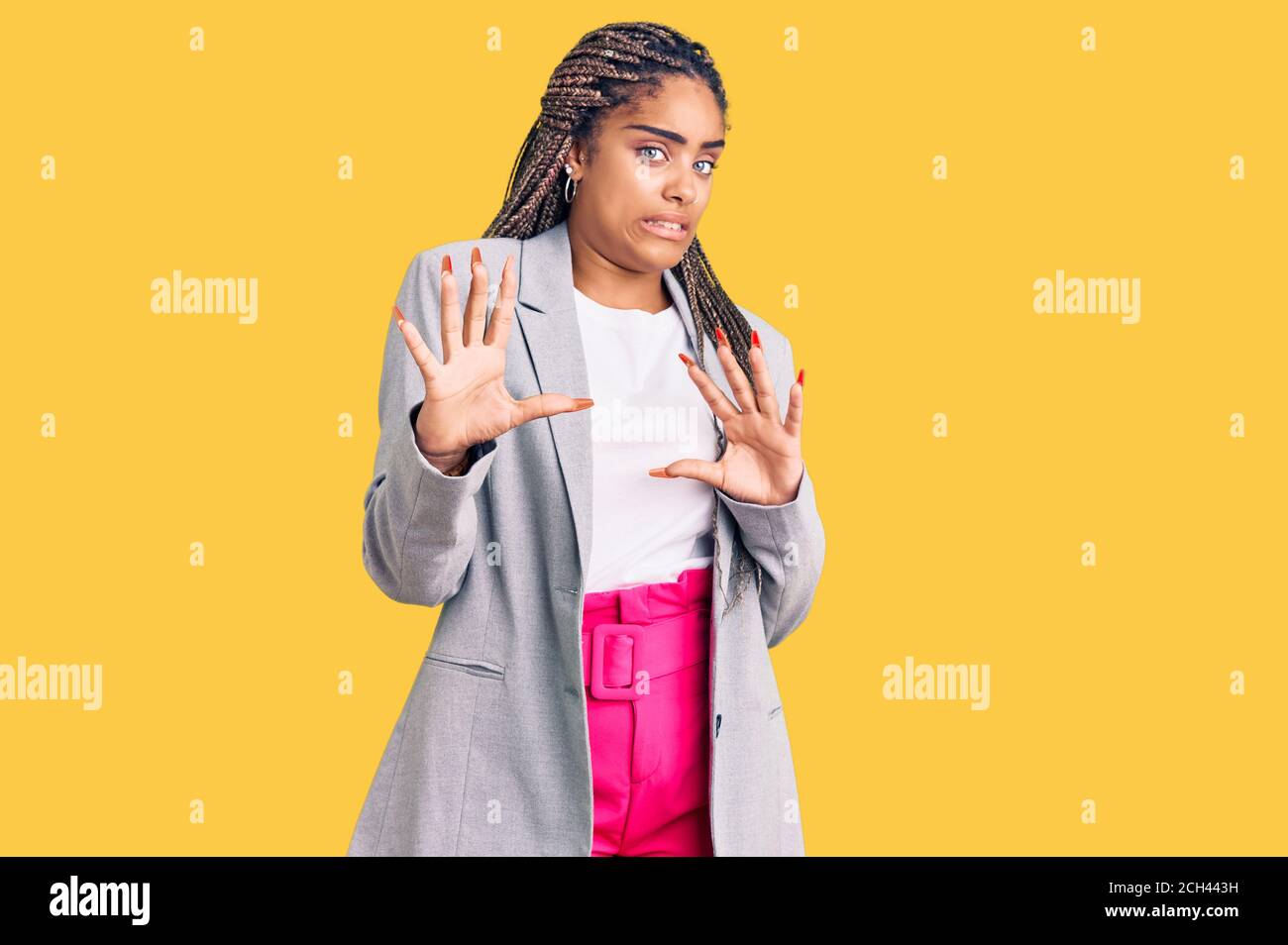 Young african american woman with braids wearing business clothes ...