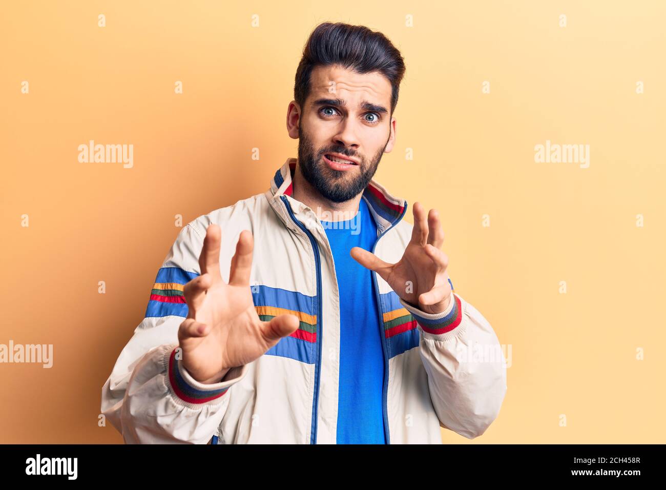 Young handsome man with beard wearing casual jacket disgusted ...