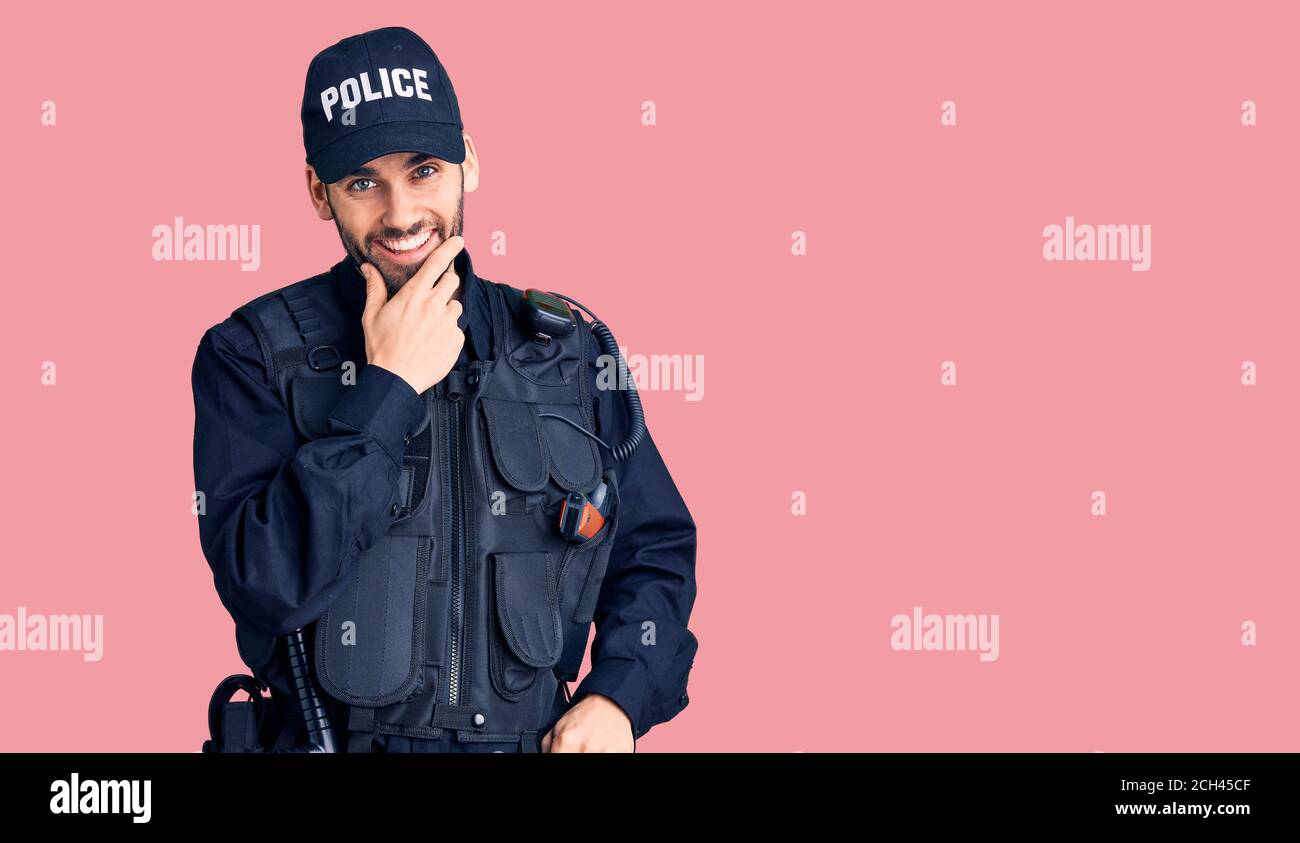 Young handsome man with beard wearing police uniform looking confident ...