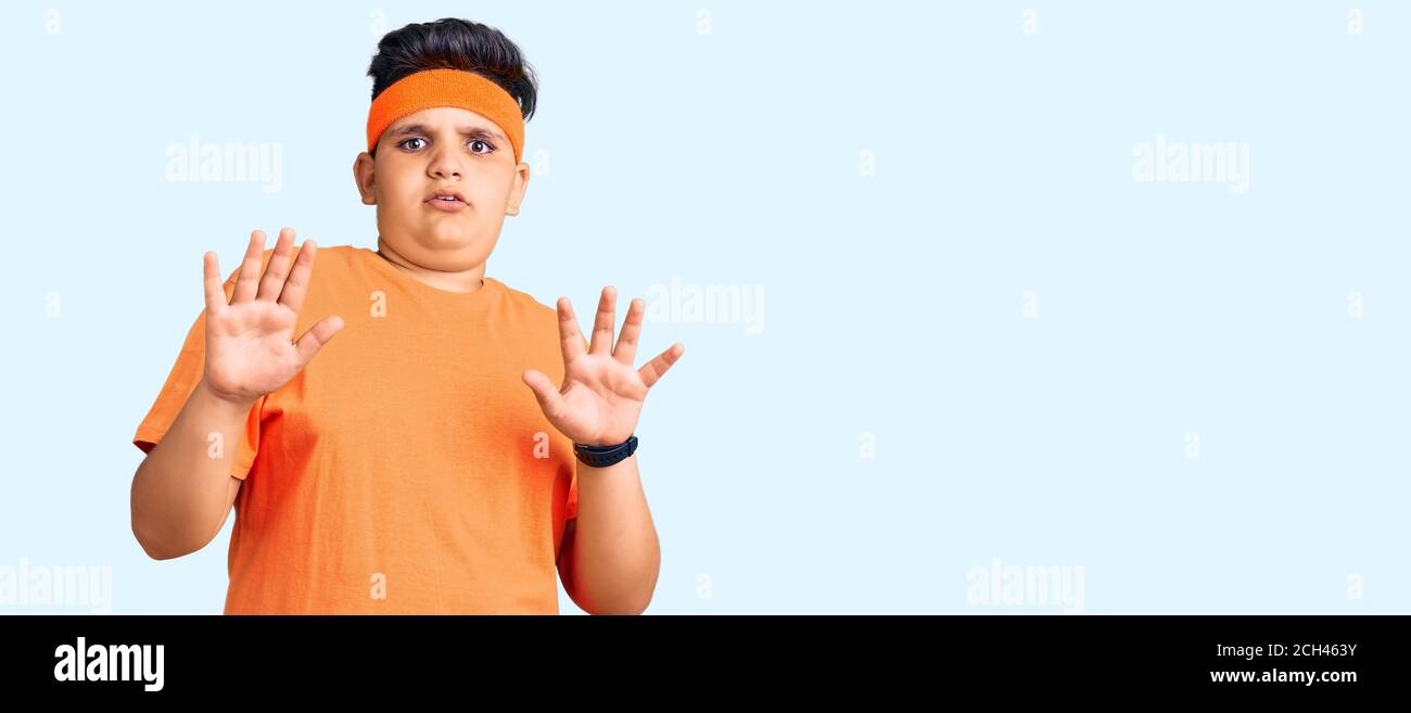Little boy kid wearing sportswear afraid and terrified with fear ...