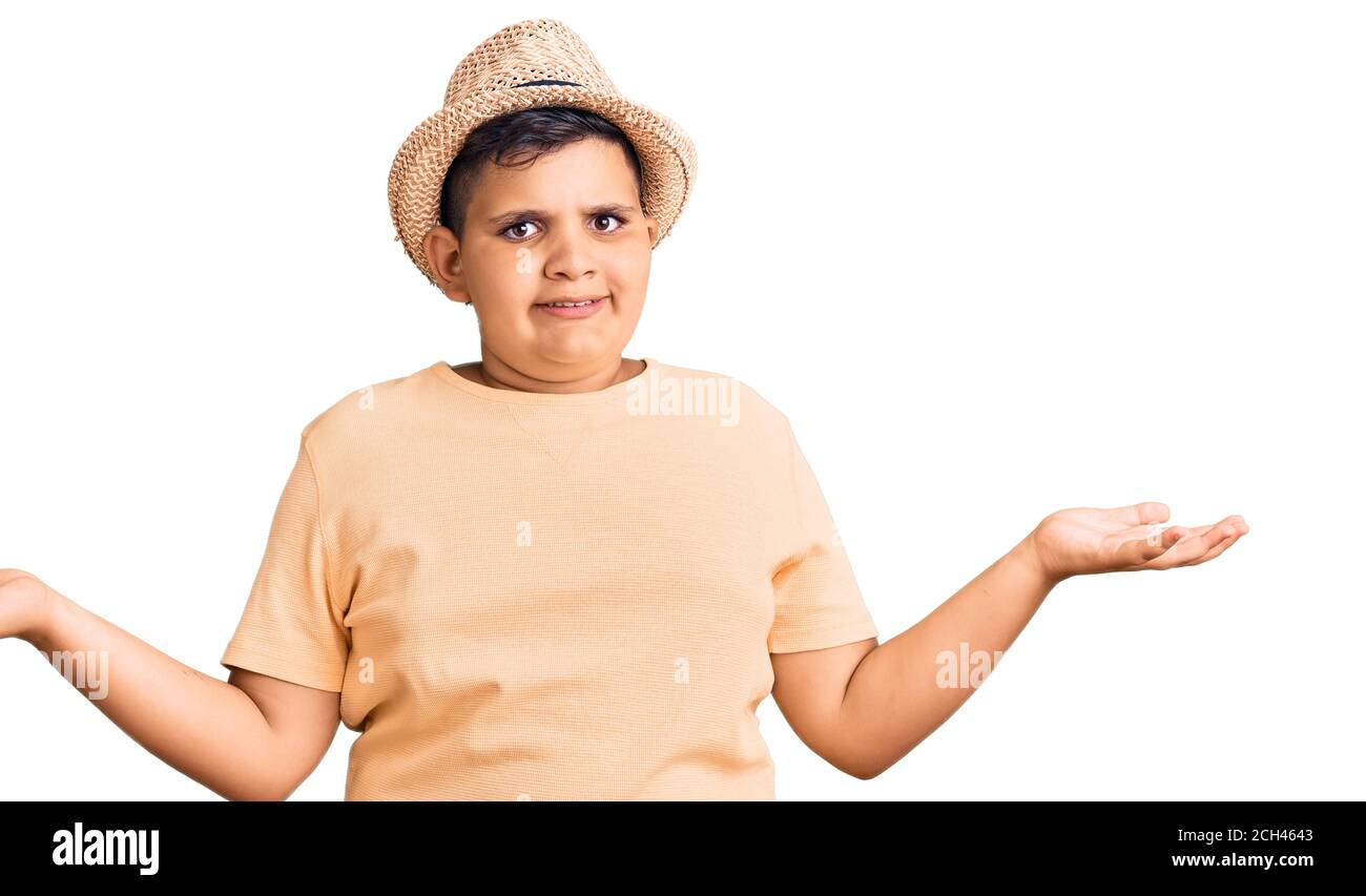 Little boy kid wearing summer hat and hawaiian swimsuit clueless and ...