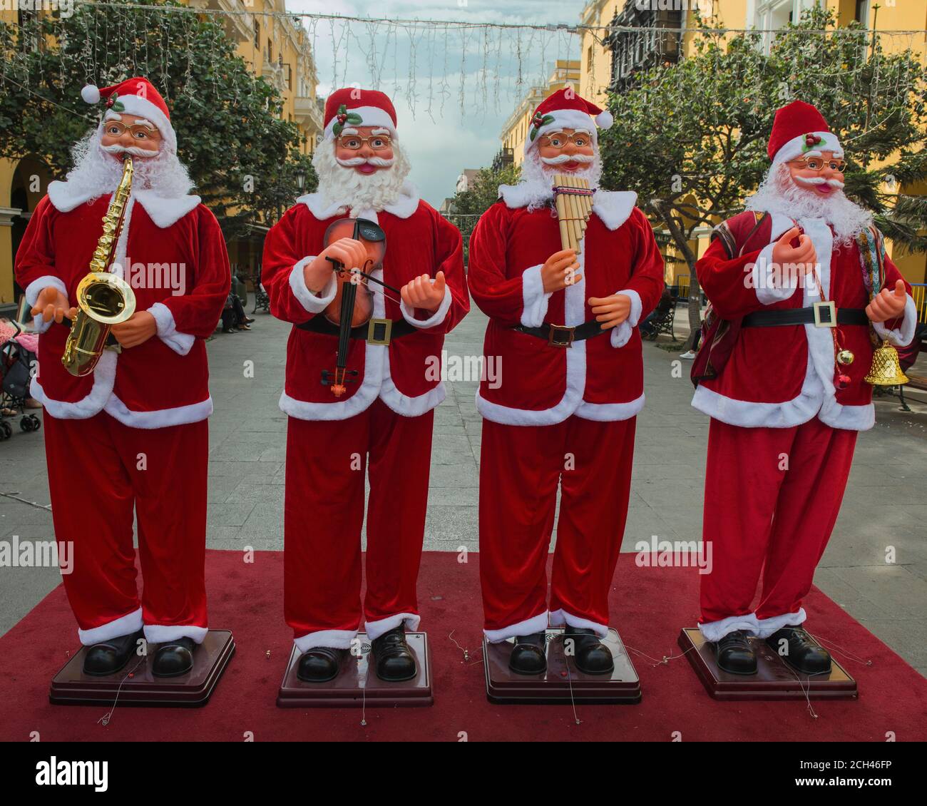 Musicians street performance, men in Santa Claus costumes playing music ...
