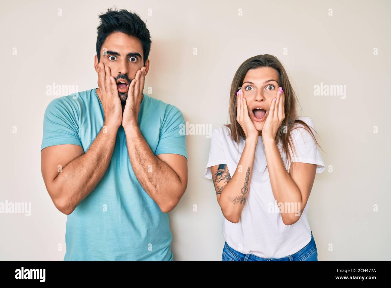 Beautiful young couple of boyfriend and girlfriend together afraid and ...