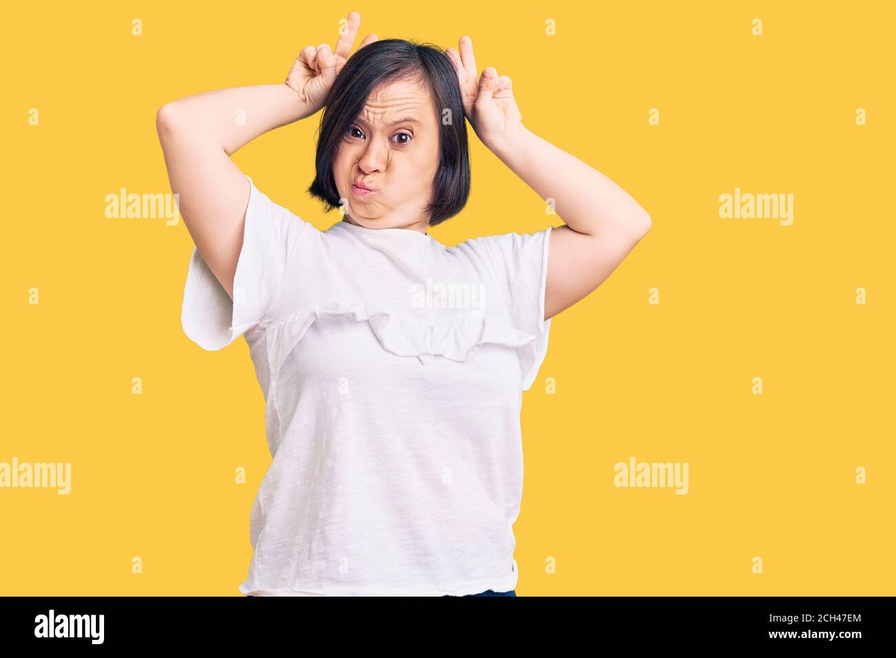 Brunette woman with down syndrome wearing casual white tshirt doing ...