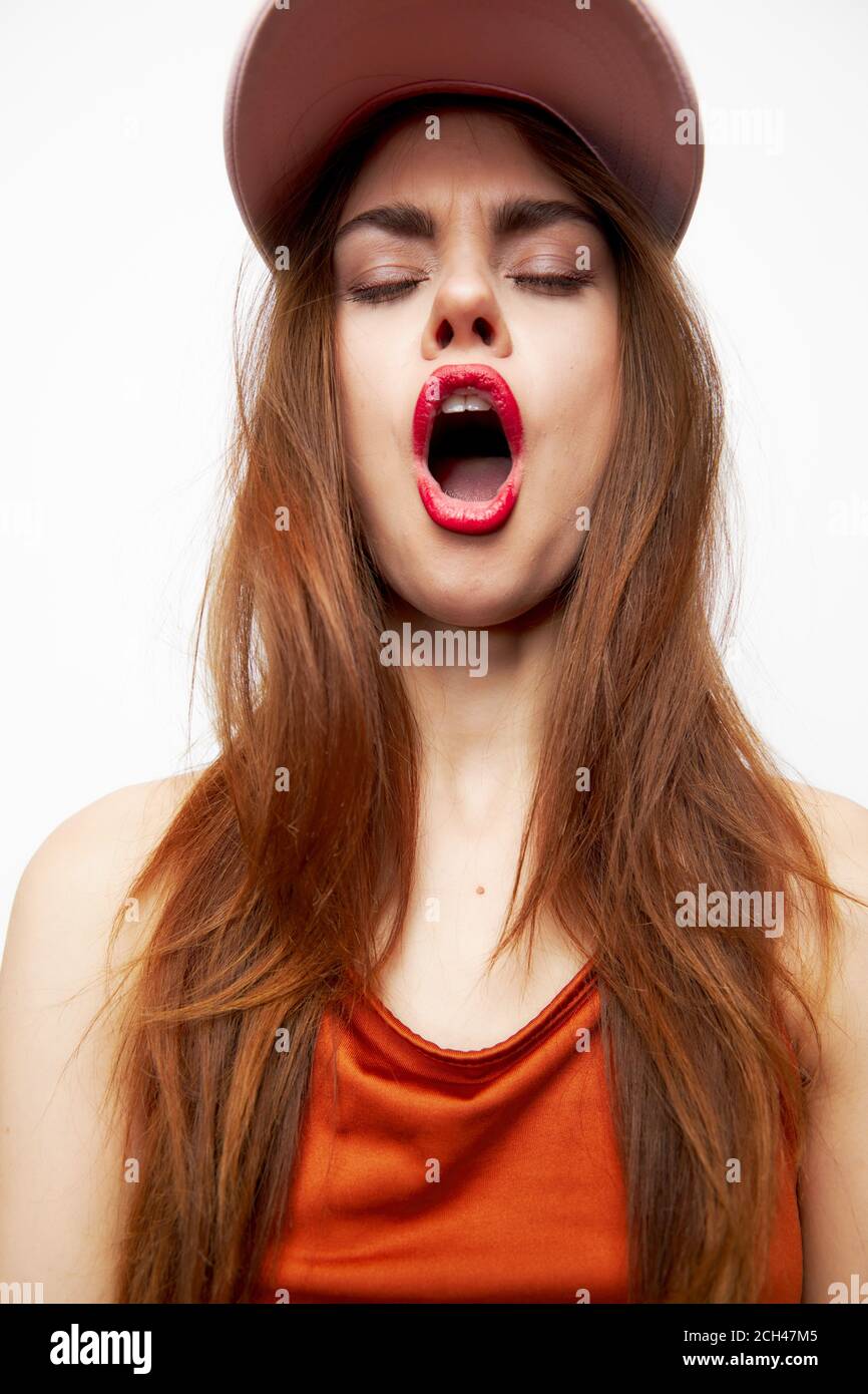 Emotional woman in a cap Open mouth closed eyes charm and luxury red ...