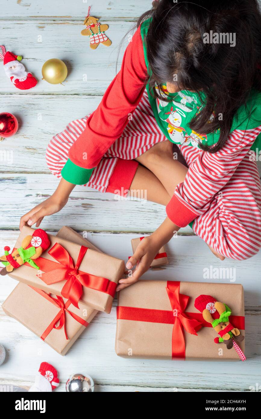 Cute brunette girl with her presents on Christmas day Stock Photo - Alamy