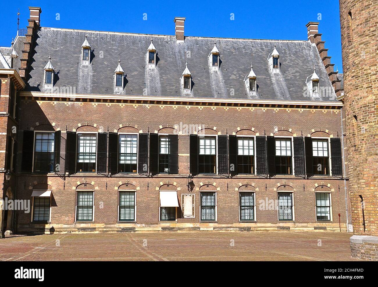 18th Century European brick building in a cobbled courtyard with ...