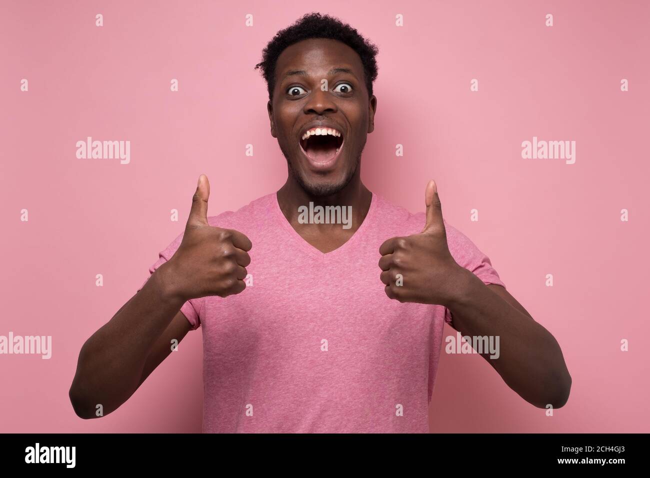 Handsome black man showing thumb up with cheerful attitude Stock Photo ...