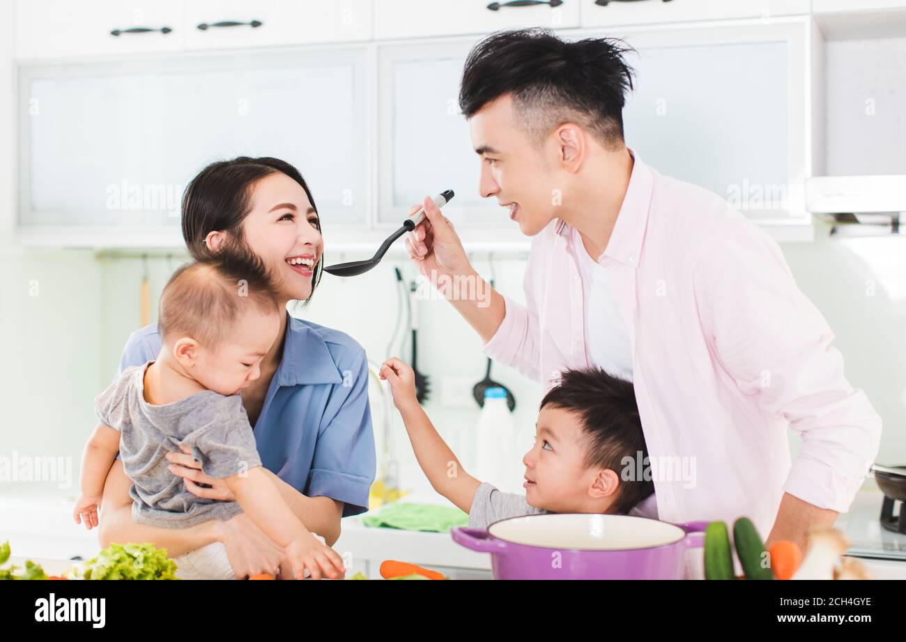 happy family tasting the soup in kitchen Stock Photo - Alamy