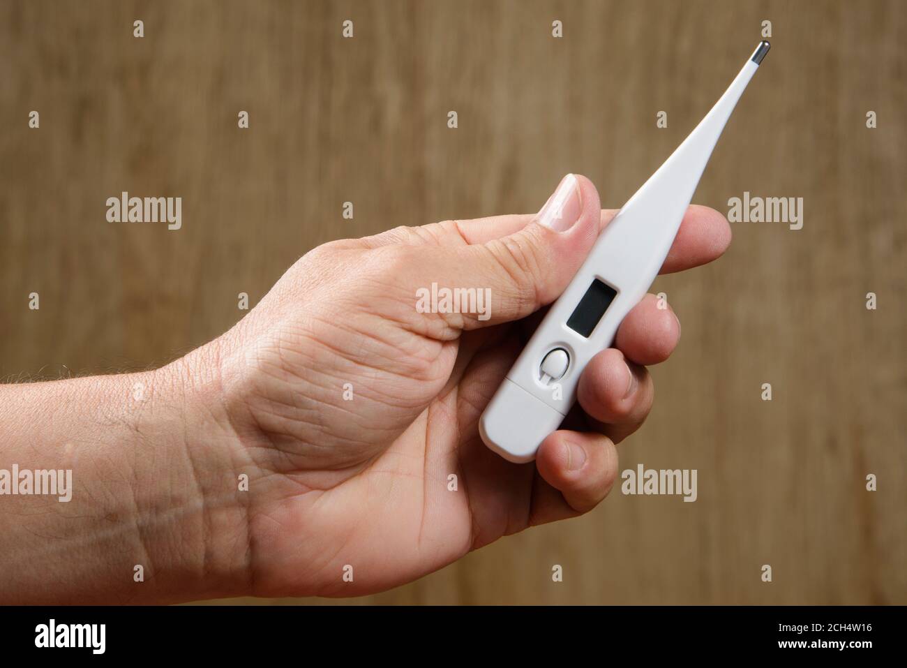 Hand holding digital thermometer hi-res stock photography and images ...