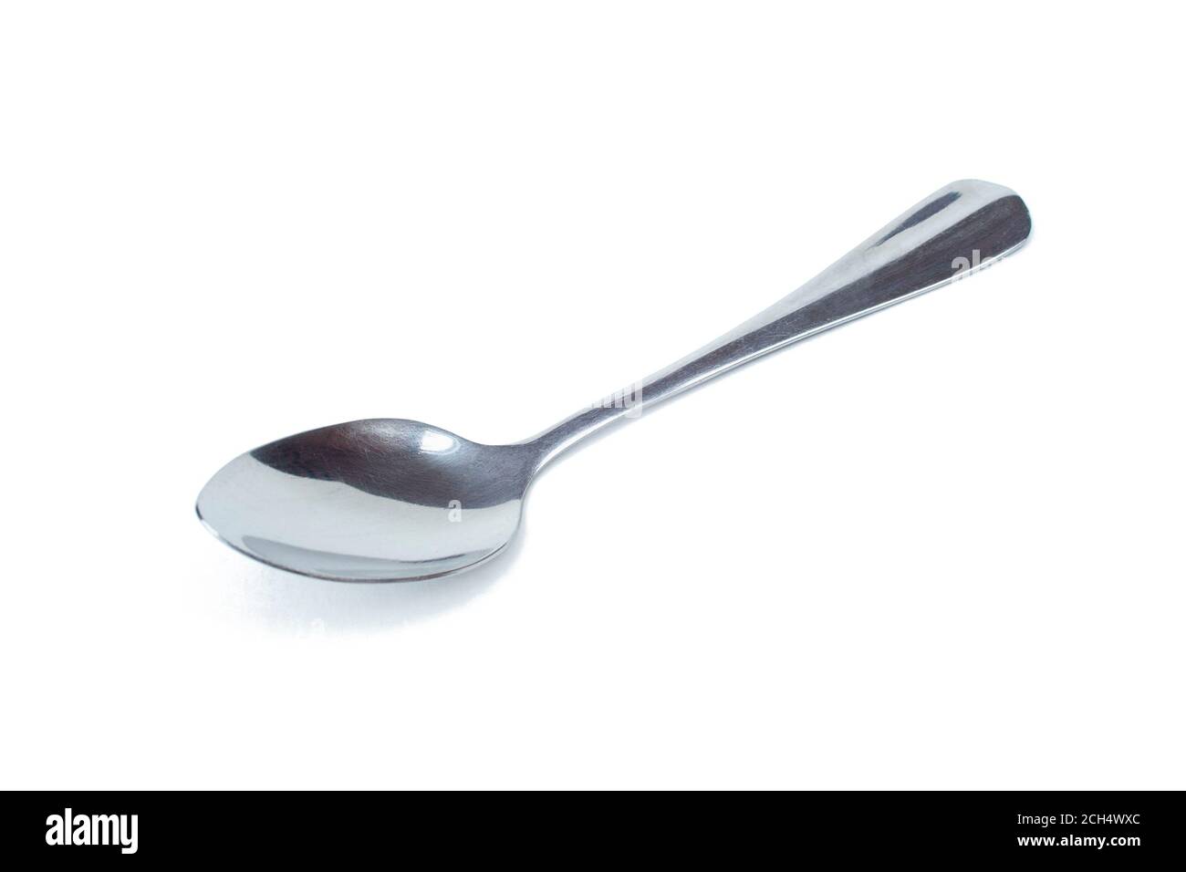 Silver shiny spoon isolated on white background Stock Photo - Alamy