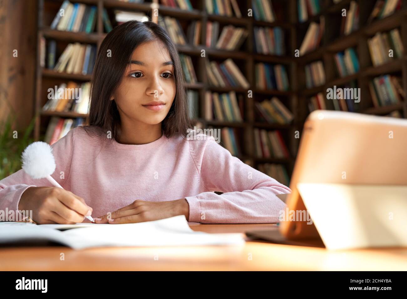 Indian lating school girl learning online class watching video lesson ...