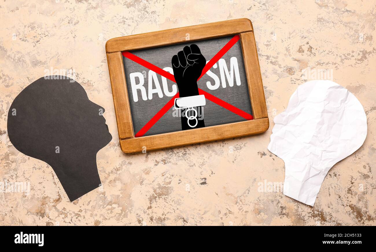 Paper human heads with chalkboard on light background. Racism concept ...