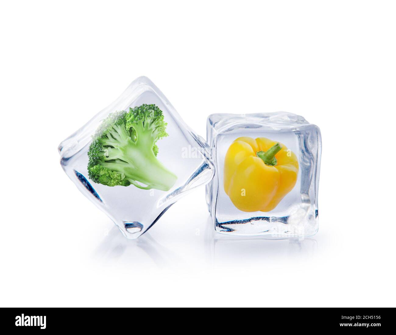 Ice cubes with yellow bell pepper and broccoli cabbage on white ...