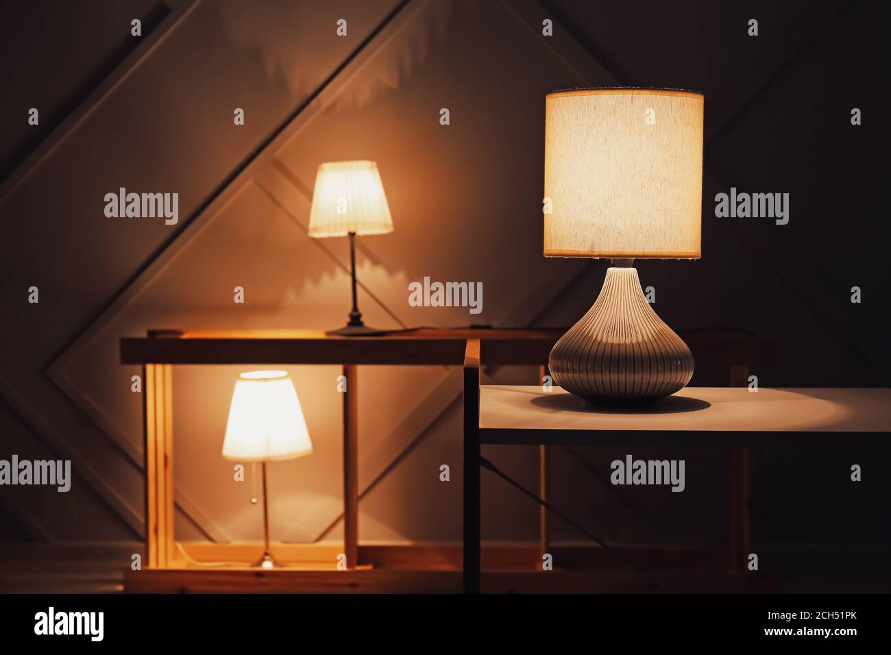 Glowing lamps in dark room Stock Photo - Alamy