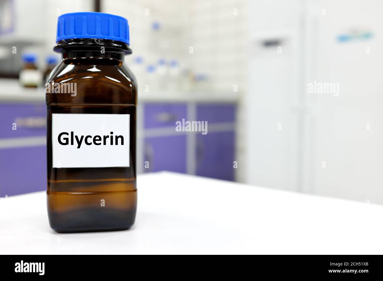Selective focus of glycerin glass bottle in a white laboratory ...