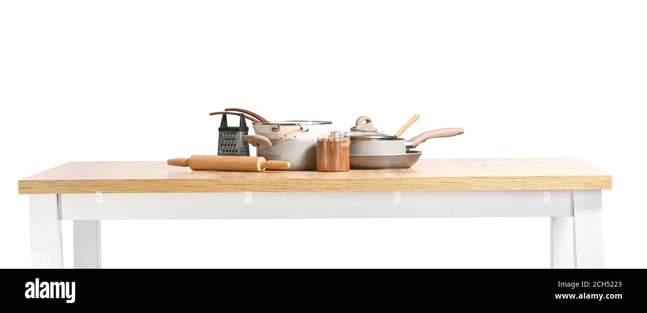 Clean utensils on kitchen table against white background Stock Photo ...