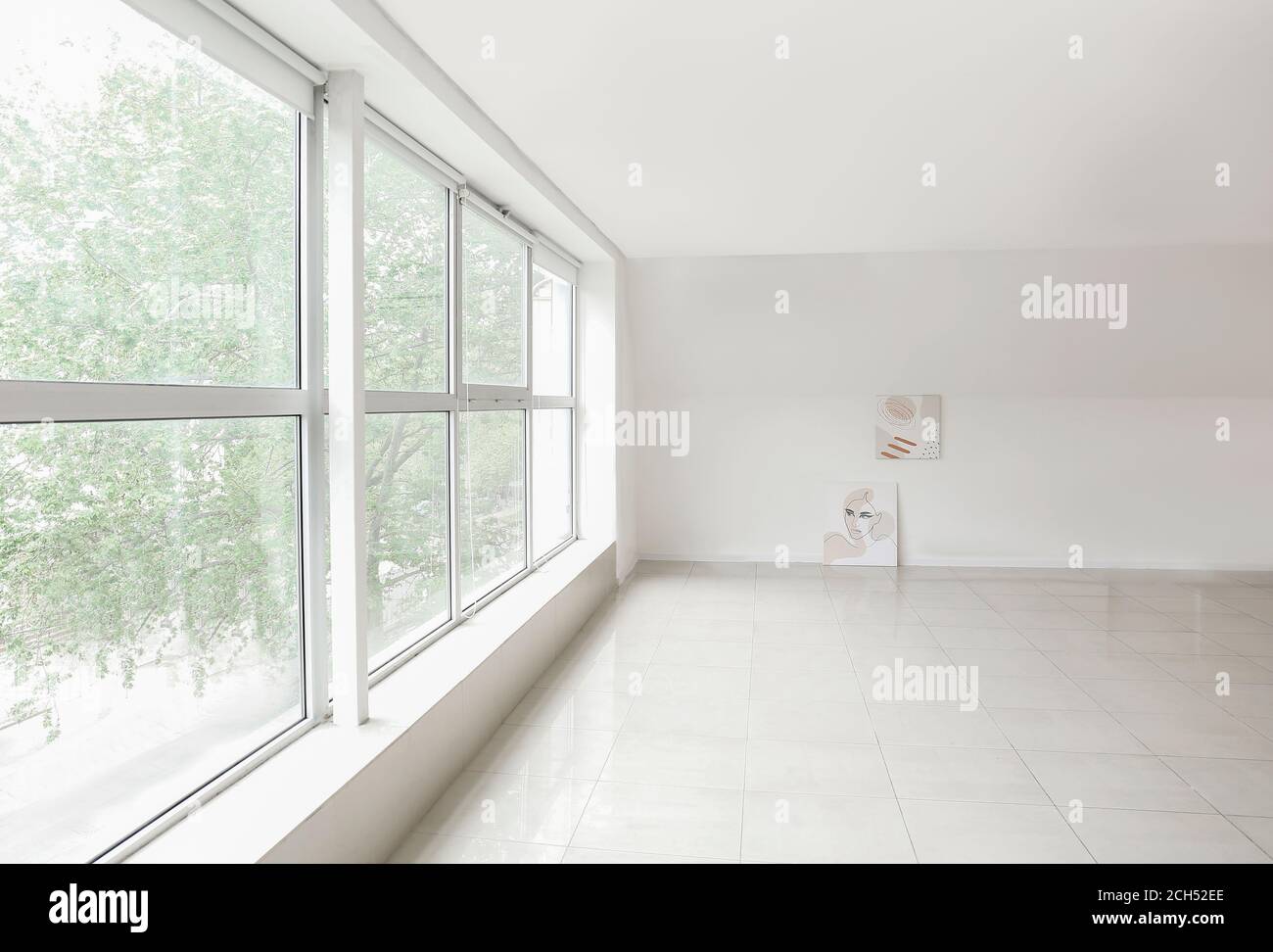 Pictures in big empty room Stock Photo - Alamy