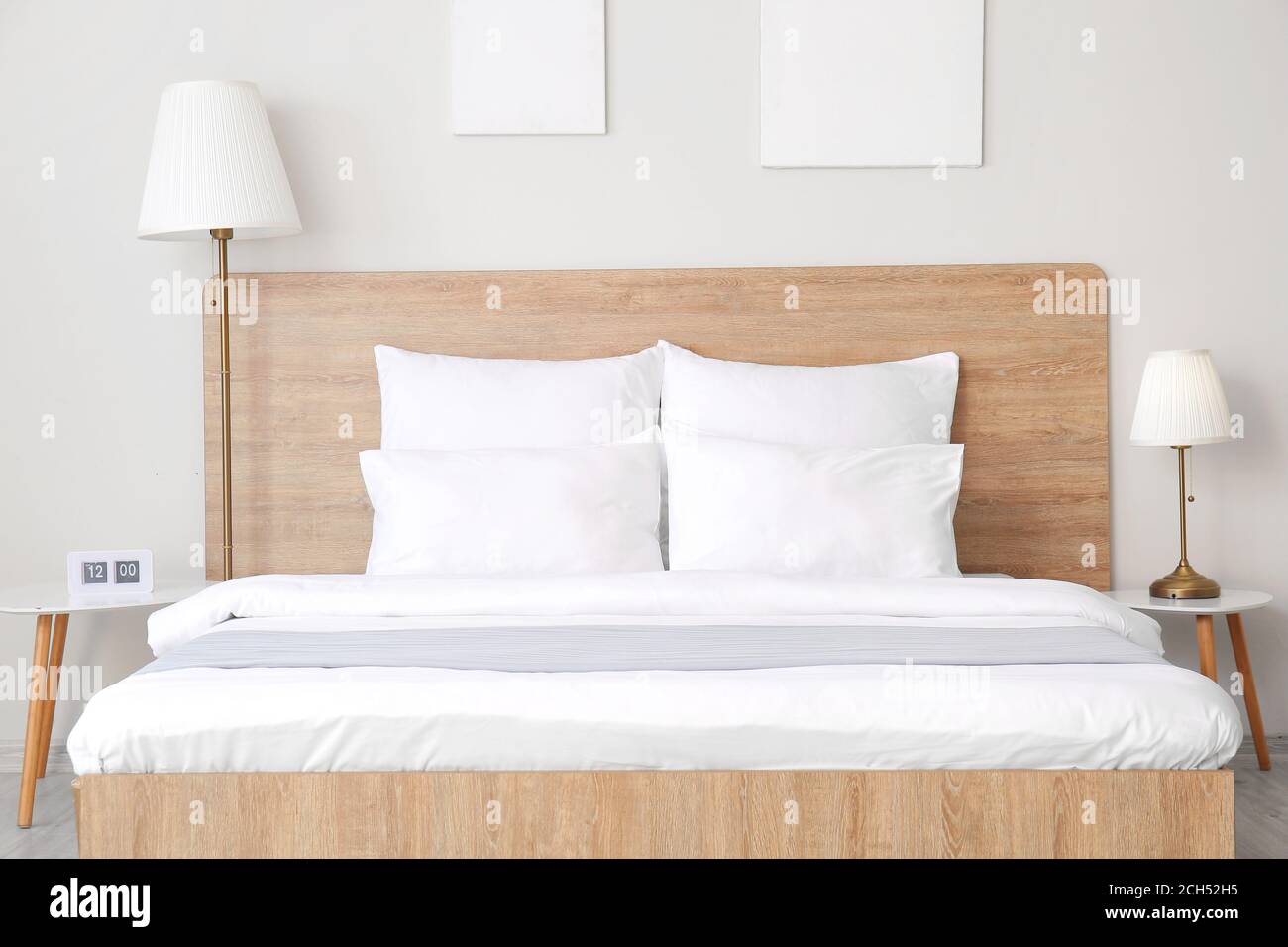 Big comfortable bed in hotel room Stock Photo - Alamy
