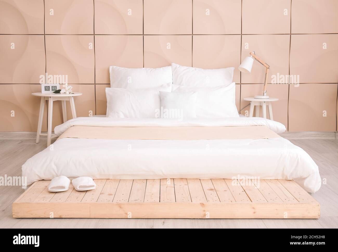 Big comfortable bed in hotel room Stock Photo - Alamy
