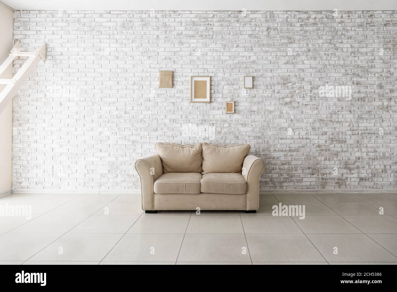 Comfortable sofa in empty room Stock Photo - Alamy