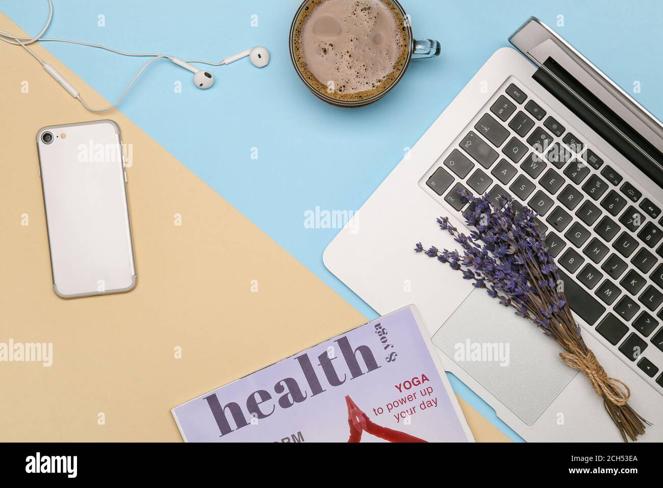Laptop with mobile phone and cup of coffee on color background Stock ...