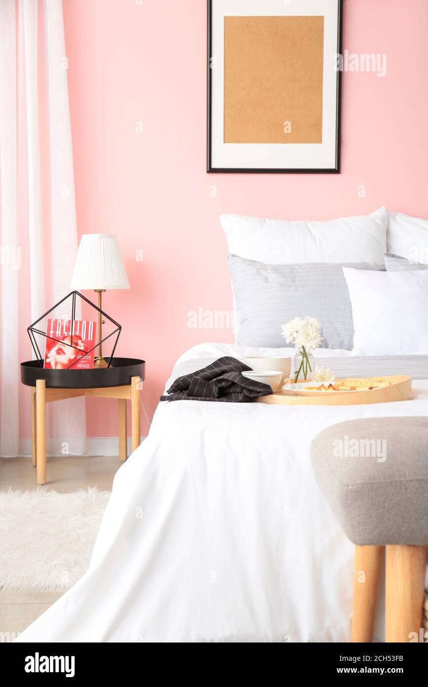 Stylish interior of room with big bed Stock Photo - Alamy