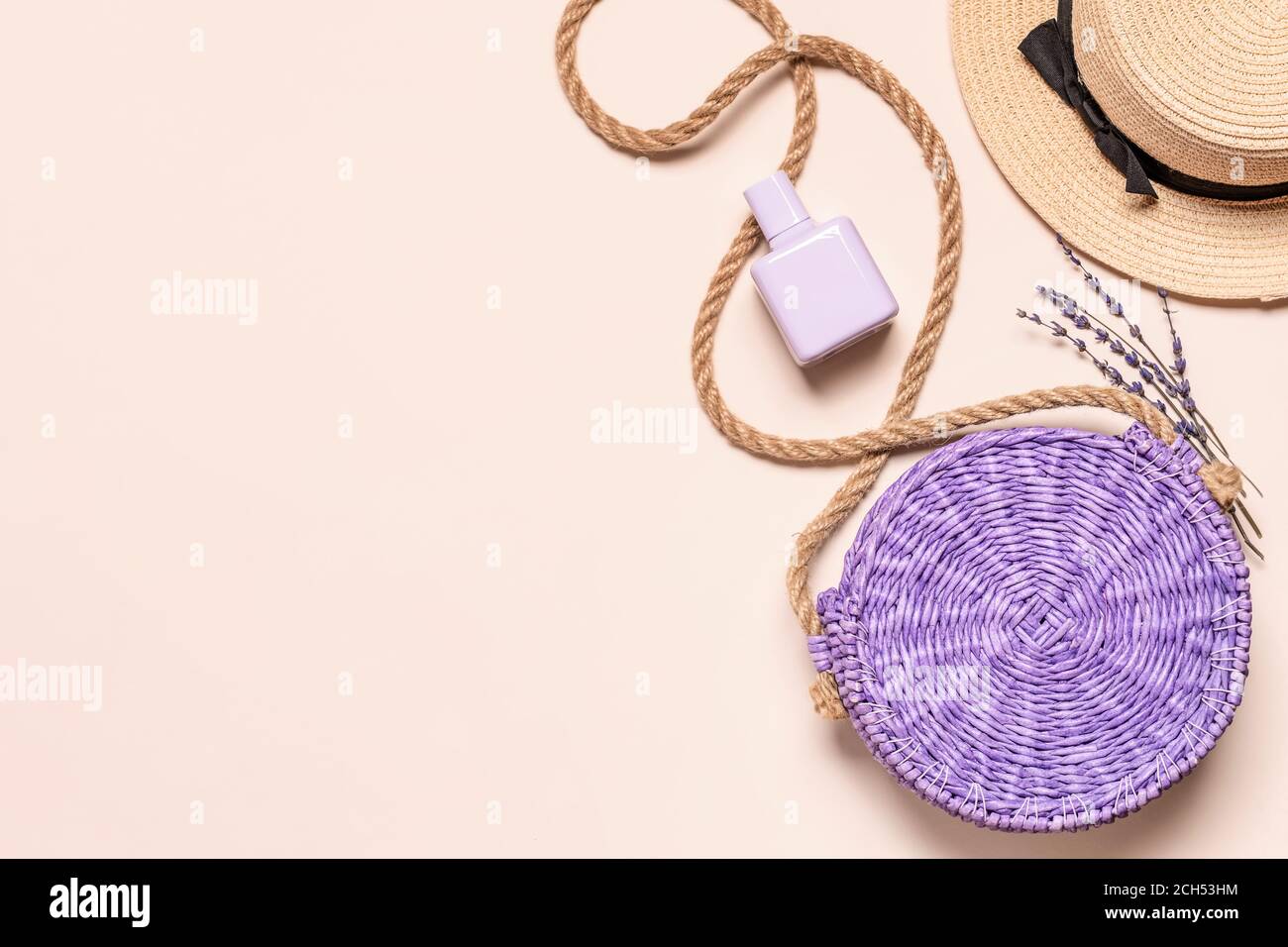 Straw hat and bag with perfume bottle on light background Stock Photo ...