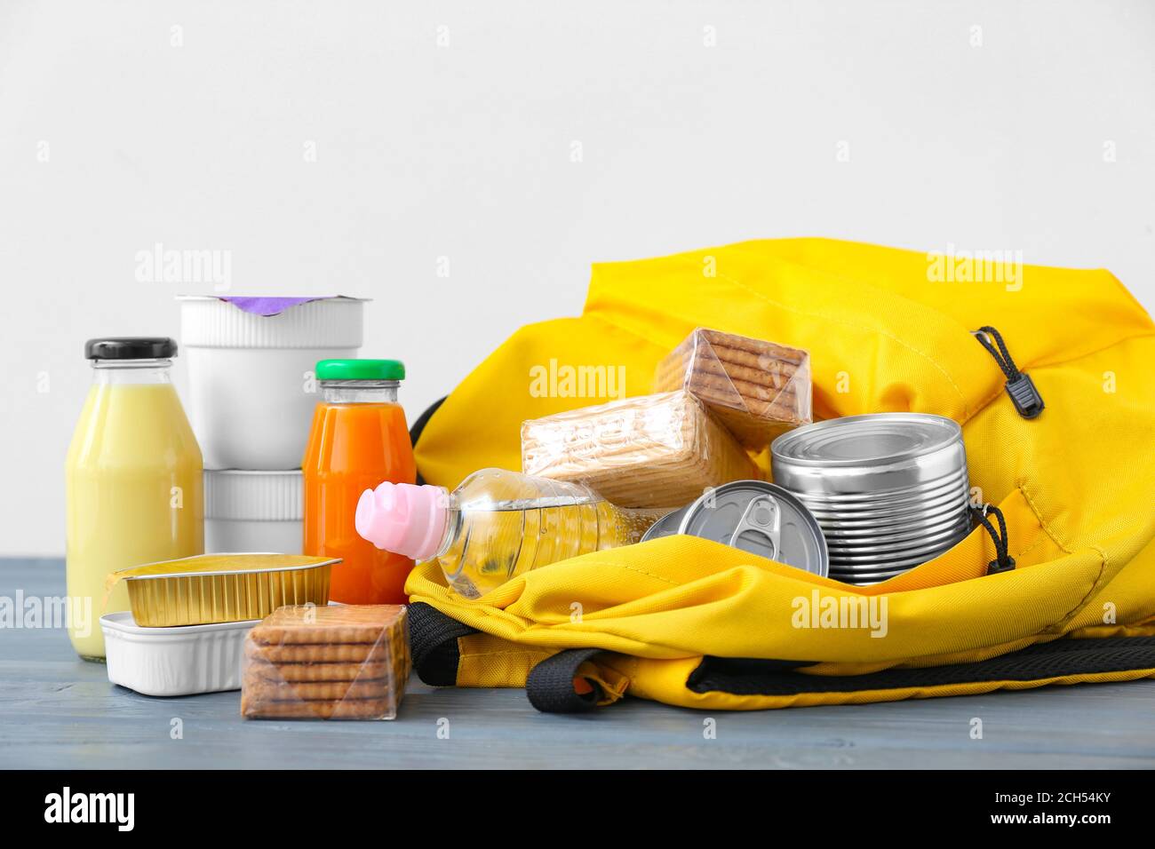 Schoolbag with different products on table. Concept of Backpack Food ...