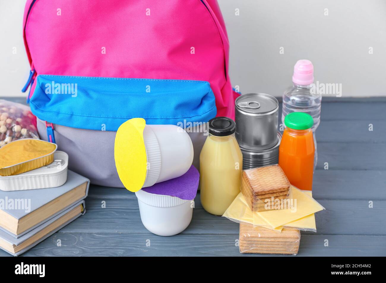 Schoolbag with different products on table. Concept of Backpack Food ...