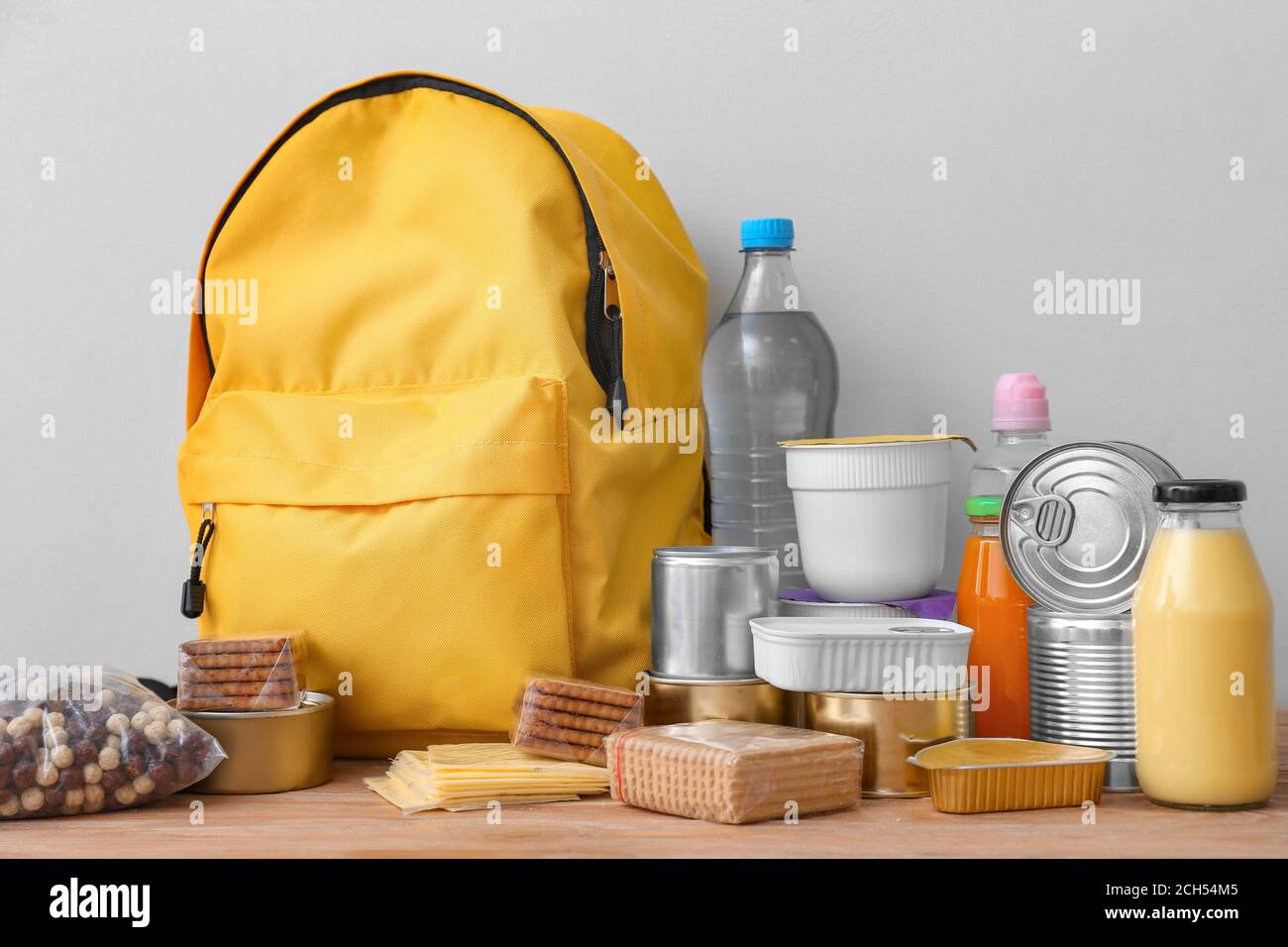 Schoolbag with different products on table. Concept of Backpack Food ...